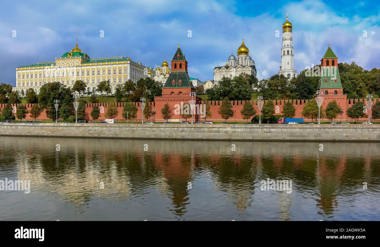 Daytime view of the red Kremlin wall, tower and golden onion domes of ...