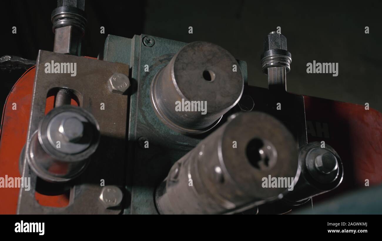 Forge workshop on table. Worker bends the metal rod on the wrought iron ...