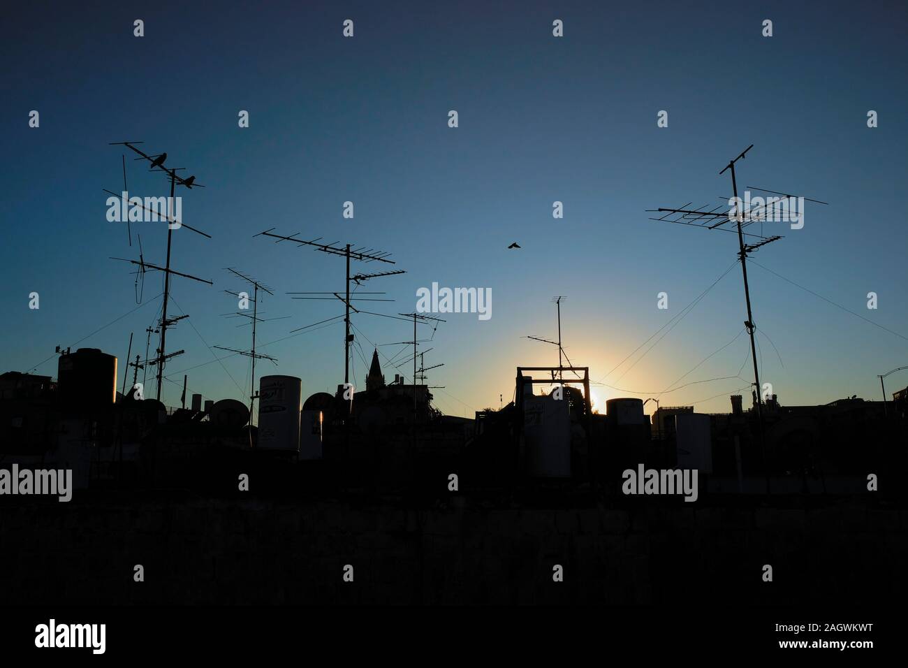 Tanks of water-heaters and TV antennas on rooftop of houses at the ...