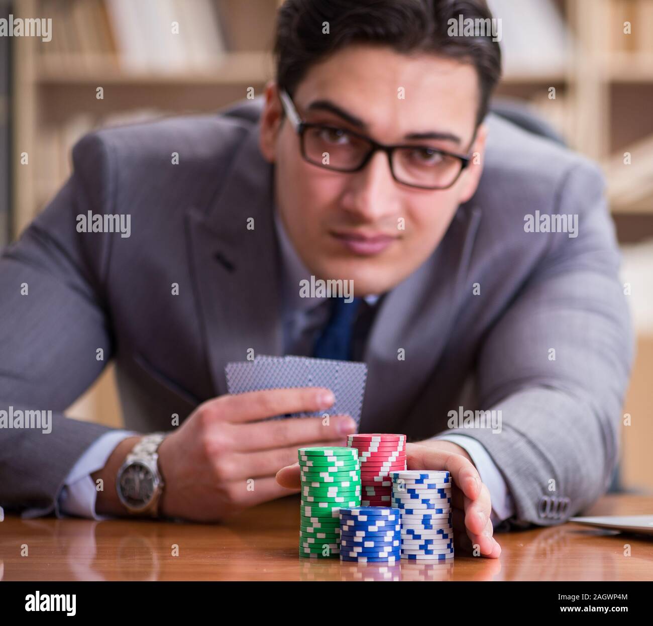 The businessman gambling playing cards at work Stock Photo - Alamy