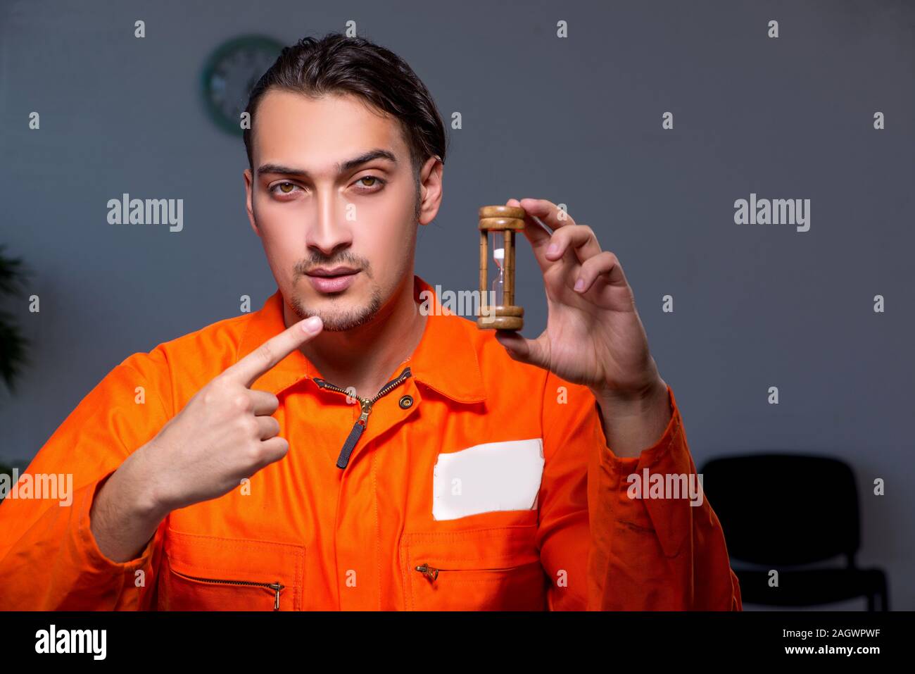The young convict man sitting in dark room Stock Photo - Alamy