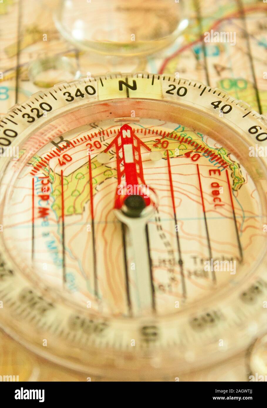 A closeup view of a modern compass on a typical map, within the United ...