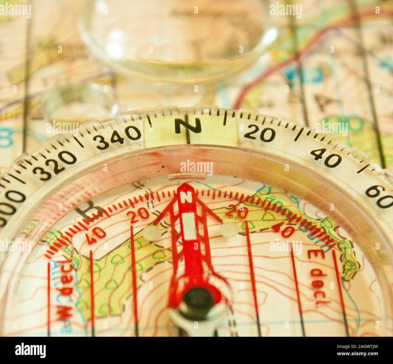 A closeup view of a modern compass on a typical map, within the United ...