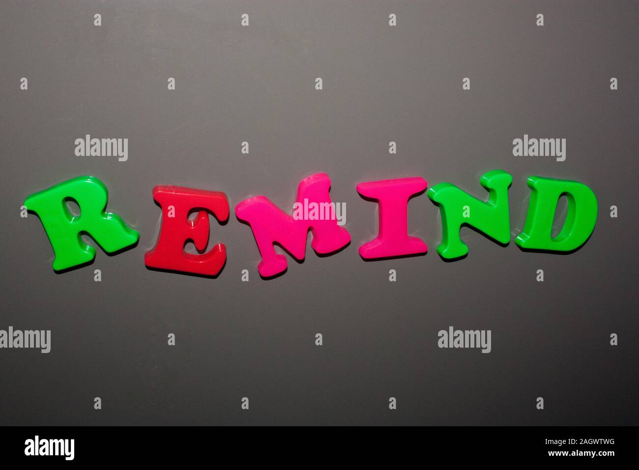 Fridge magnets arranged to show the word 'Remind' Stock Photo - Alamy