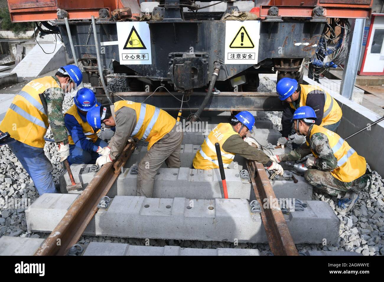 Fujian, China. 22nd Dec, 2019. Workers lay tracks at the tracklaying ...