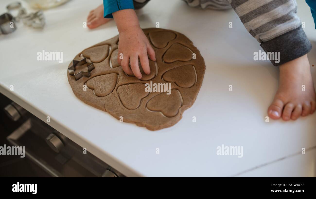 Toddler child making cookies on a kitchen counter Stock Photo - Alamy