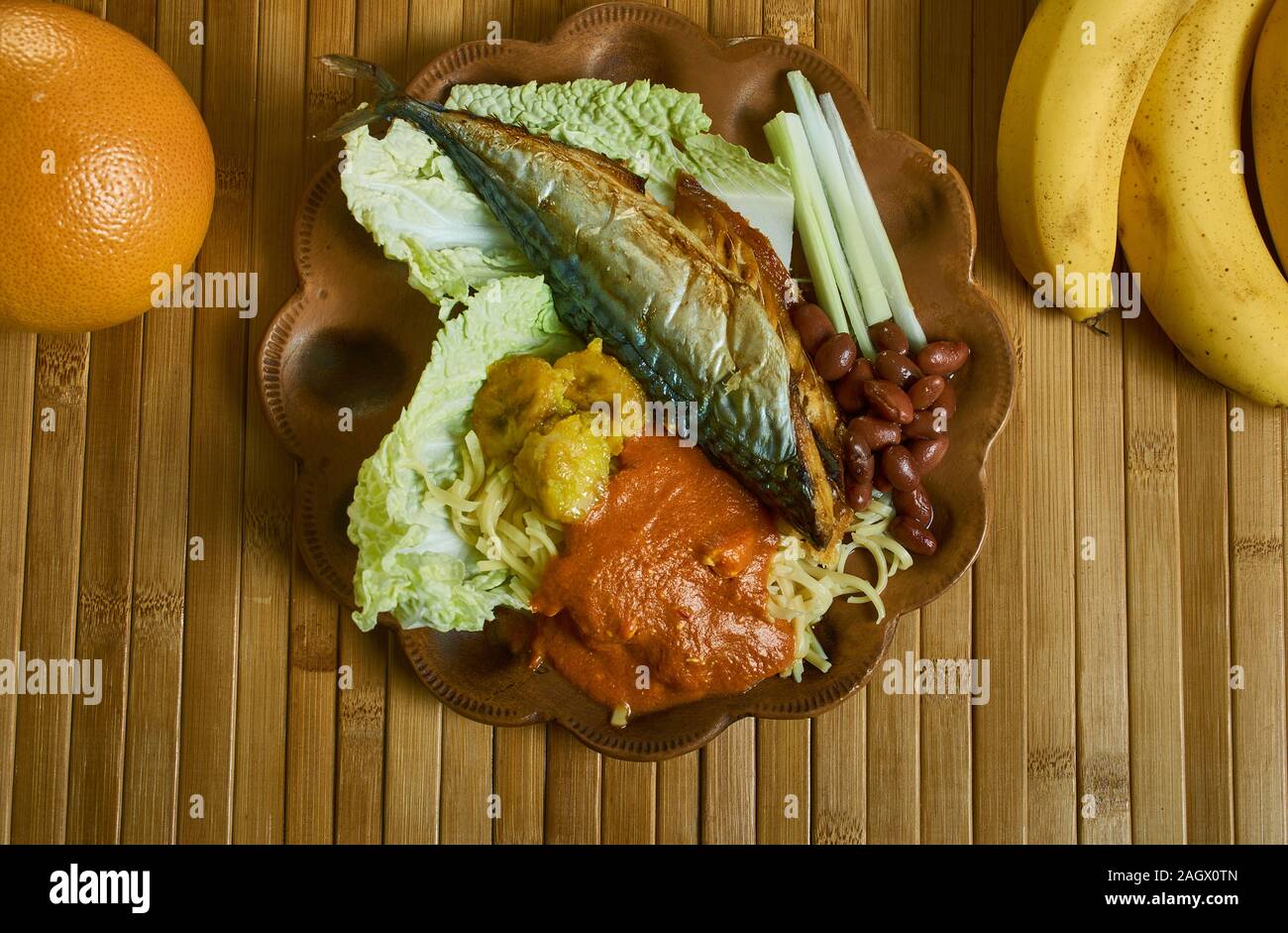 Kenkey with fried fish and chili pepper, Ghanaian cuisine, Traditional assorted African dishes ...