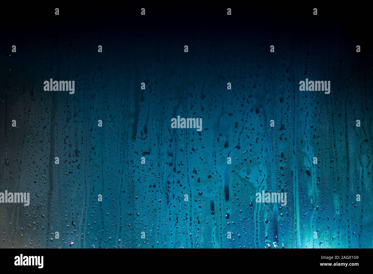 dark cyan-blue to black gradient background of night wet glass with ...