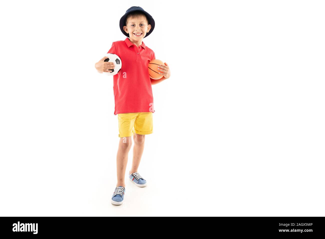 attractive young sports smiling child with a soccer ball on a white ...