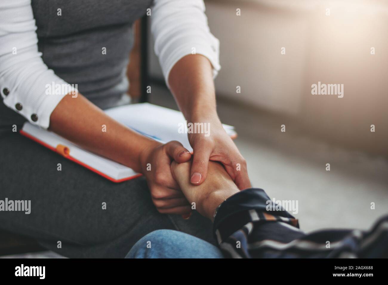 Woman support and help concept. Women hold each other's hands sitting ...