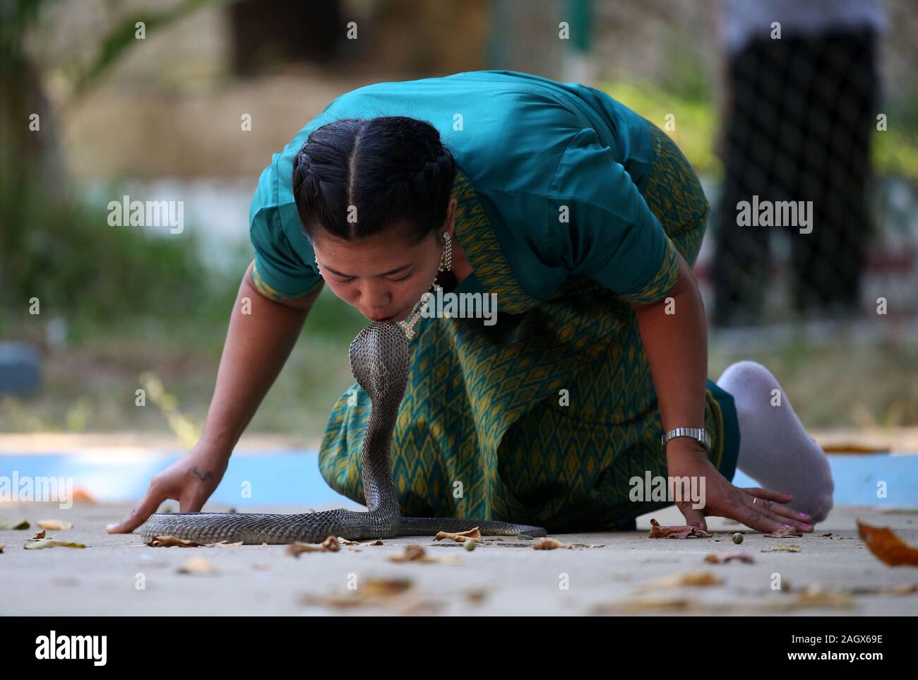 Yangon, Myanmar. 22nd Dec, 2019. A female performer kisses a snake ...
