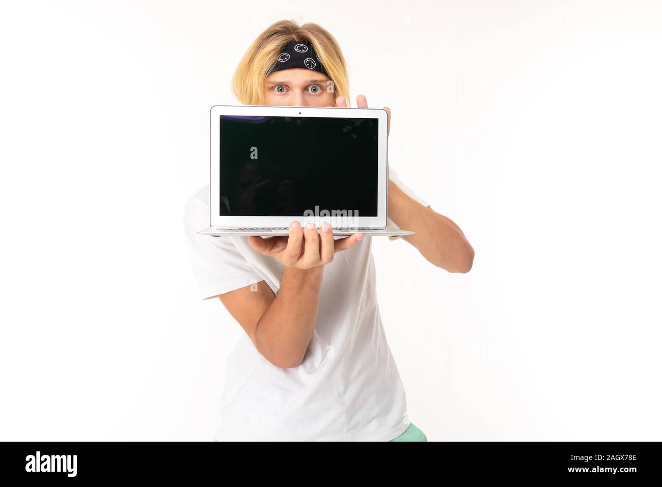 Caucasian attractive blond guy showing a blank screen with a mockup on ...