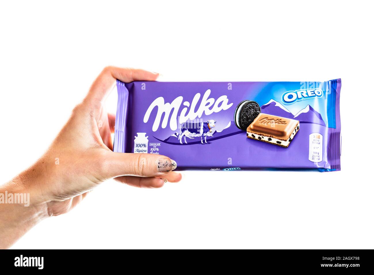 Milka Alpine Milk Chocolate. Studio shot, woman holding a Milka ...