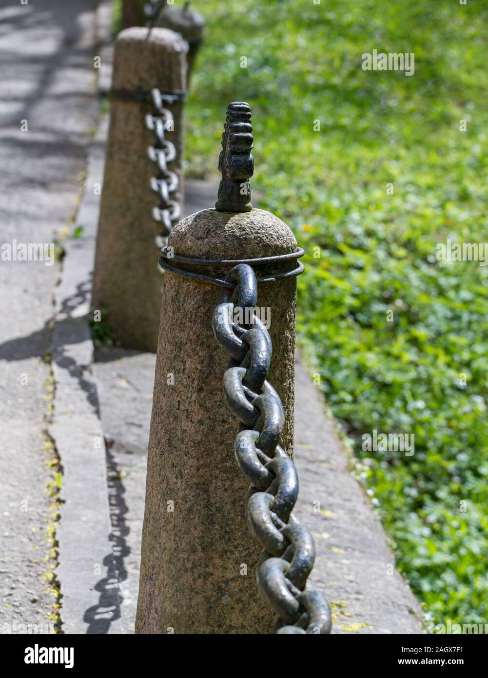 Old column with metal chain on road to the old castle Stock Photo - Alamy