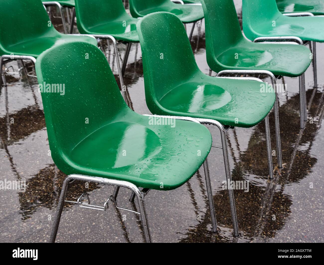Green plastic chairs after the rain Stock Photo - Alamy