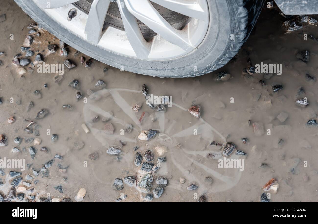 Reflection of wheel in puddle Stock Photo - Alamy
