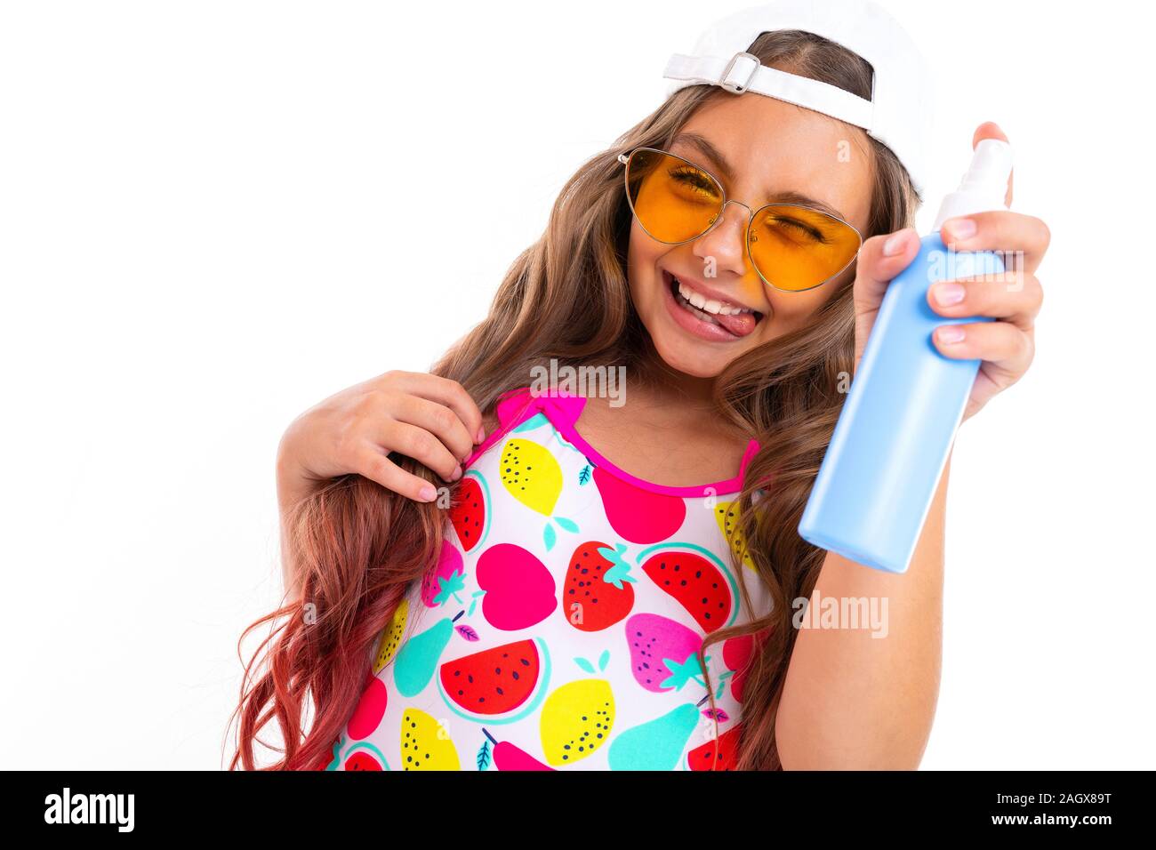 Teenager caucasian girl in glasses with cream for tanning in a spray ...