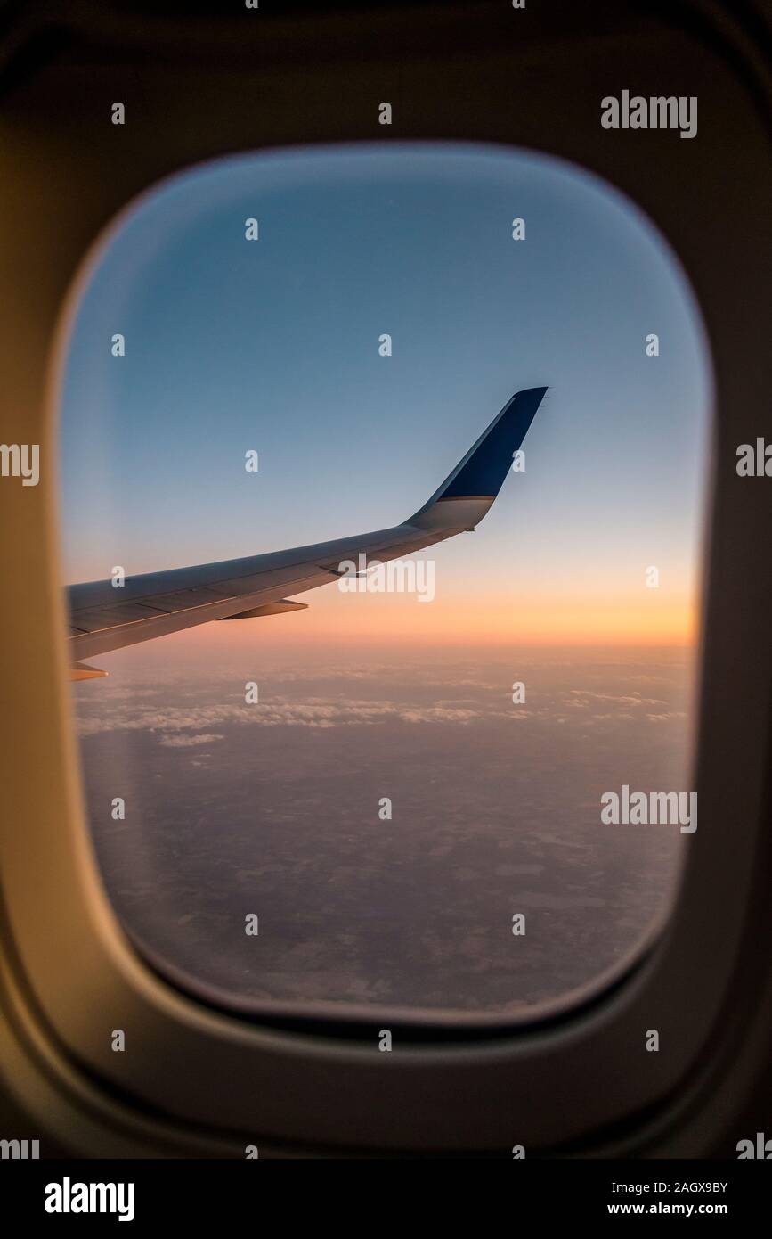 View outside of a plane window in flight at dusk Stock Photo - Alamy