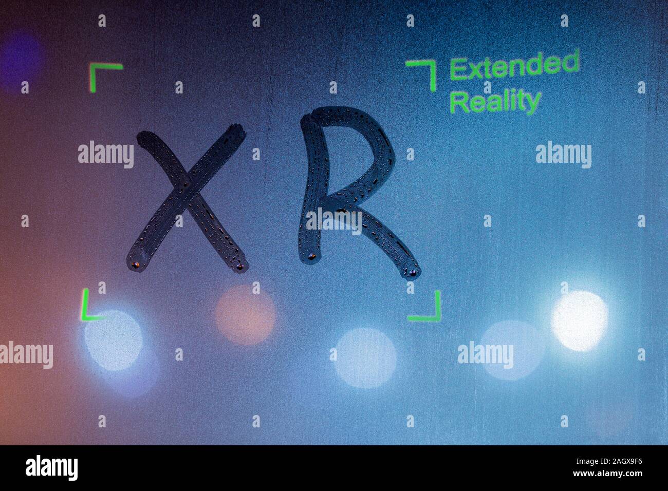 the word xr handwritten by finger on wet window glass with green ...