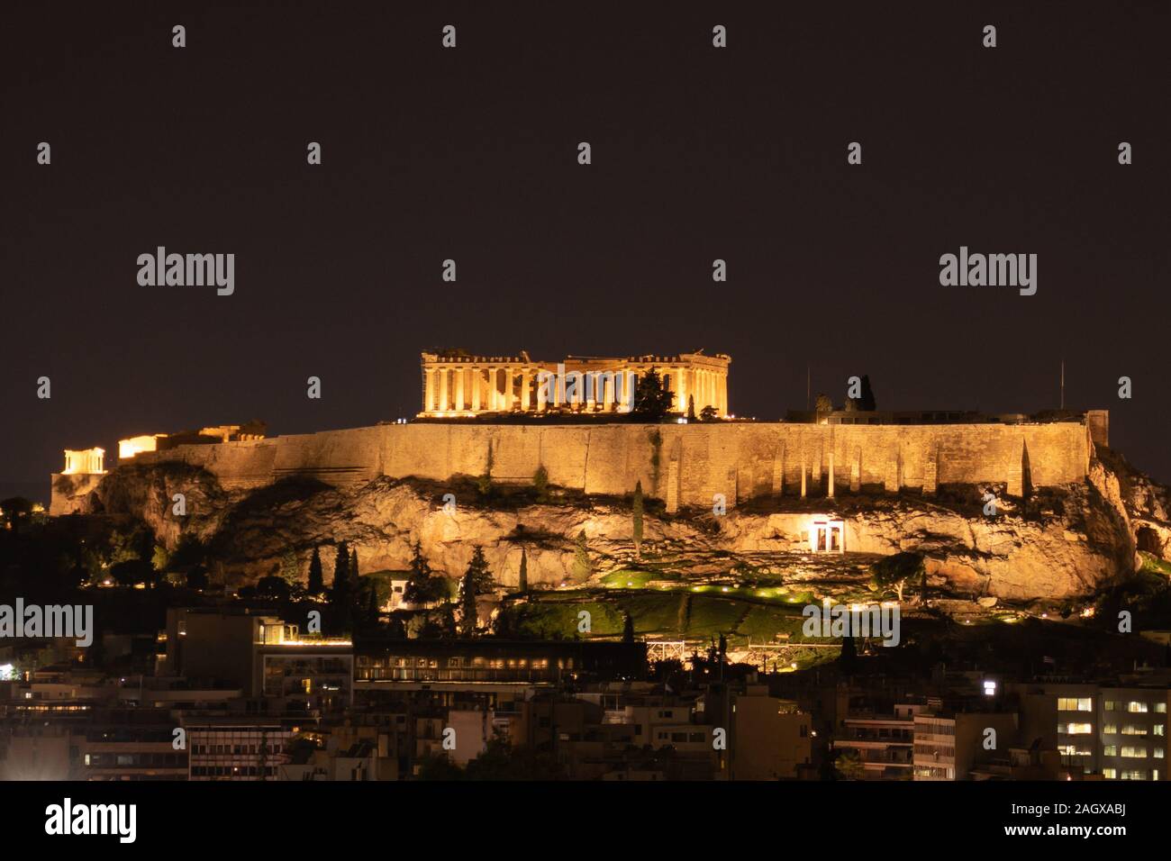 Night view of acropolis building on a hill with lights and beautiful ...