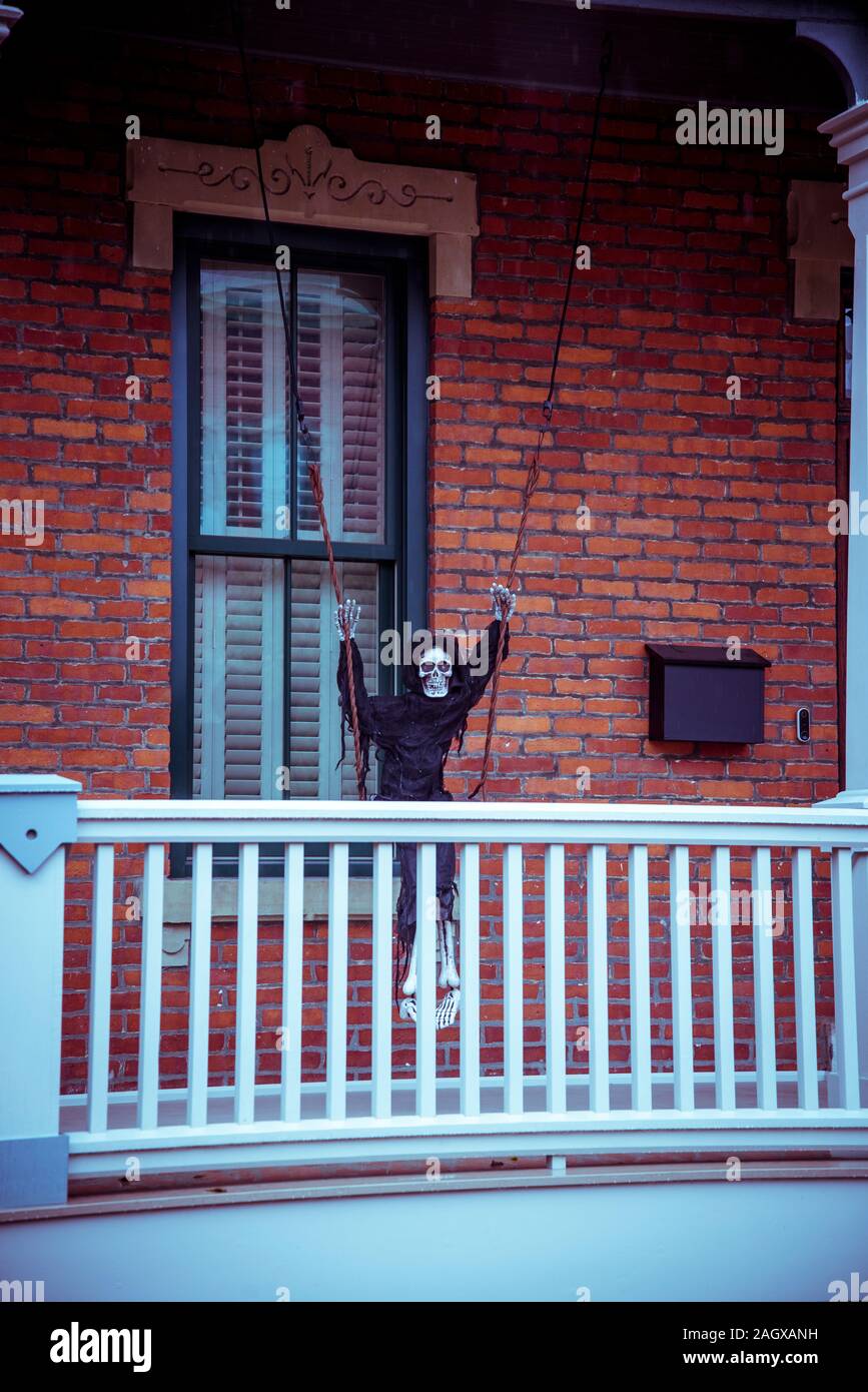 Halloween skeleton on a veranda of a Traditional residential house in ...