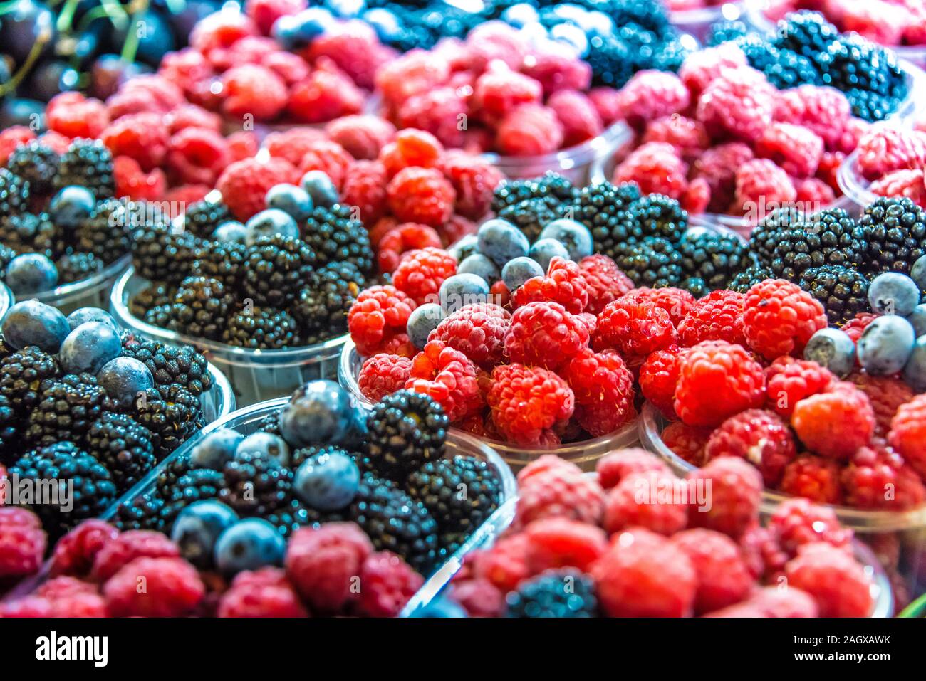 Raspberries, blueberries and blackbarries sold on the street market ...