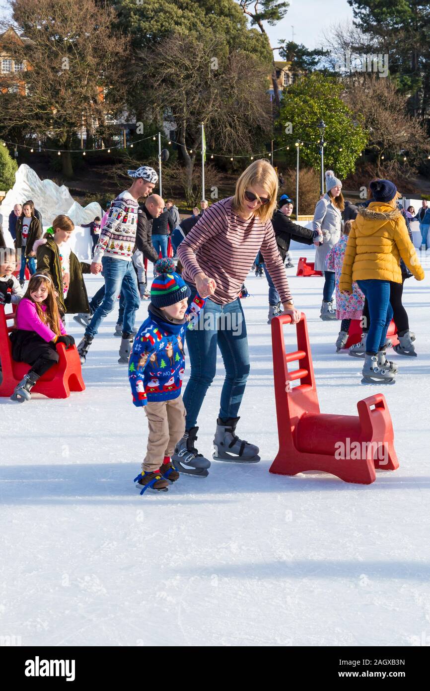 Women and kids skating on ice rink wearing winter hi-res stock ...