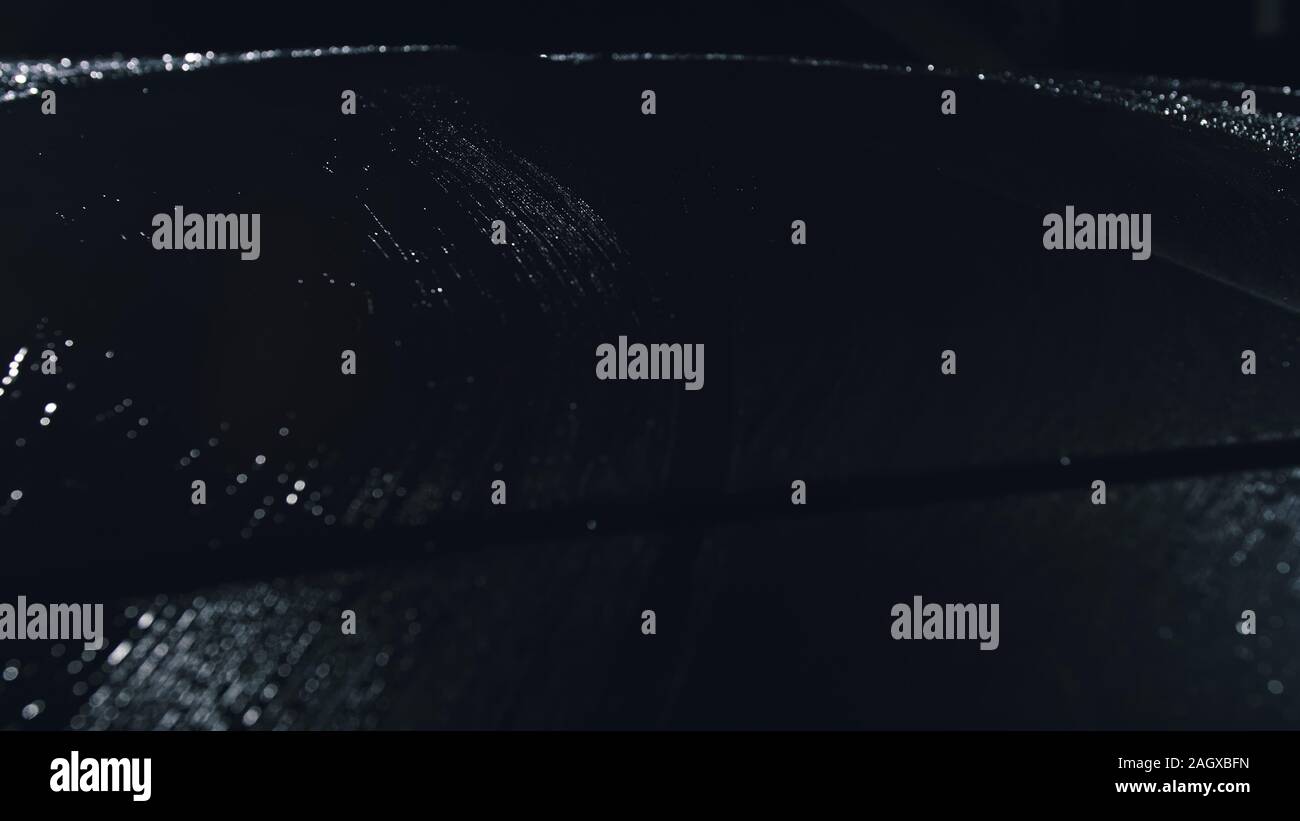 Drop flow down the hood. Close up view of bonnet car. Dark black ...