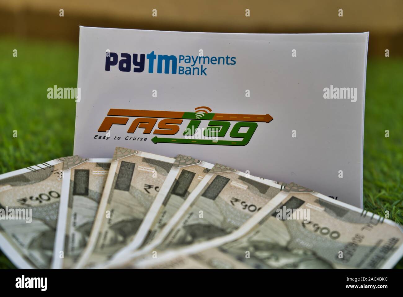 Fast Tag provided by PayTM Payment Bank on green grass with currency ...