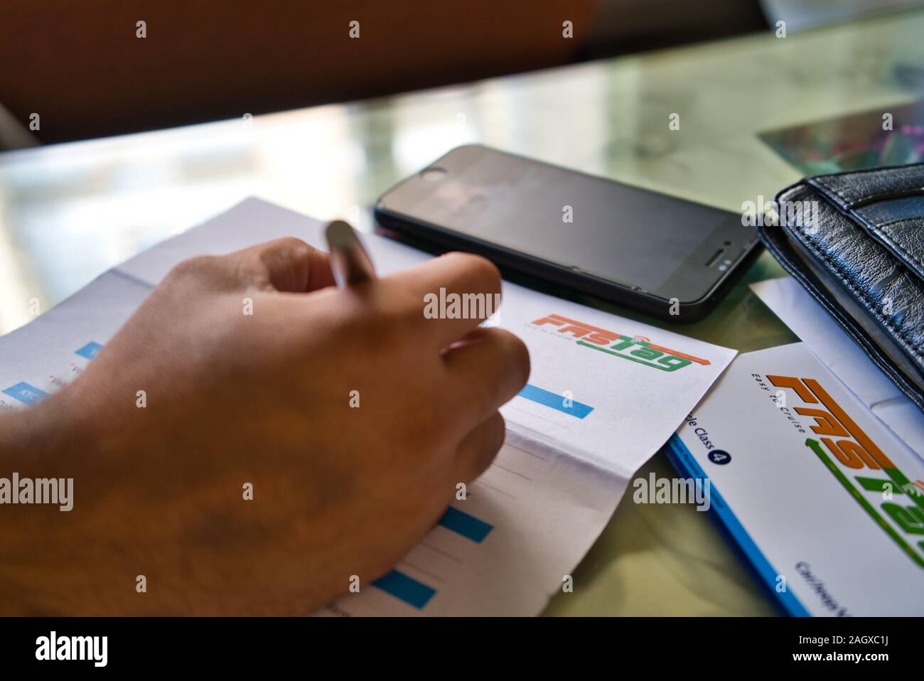 Fast Tag application form being filled with a fountain pen, along with ...