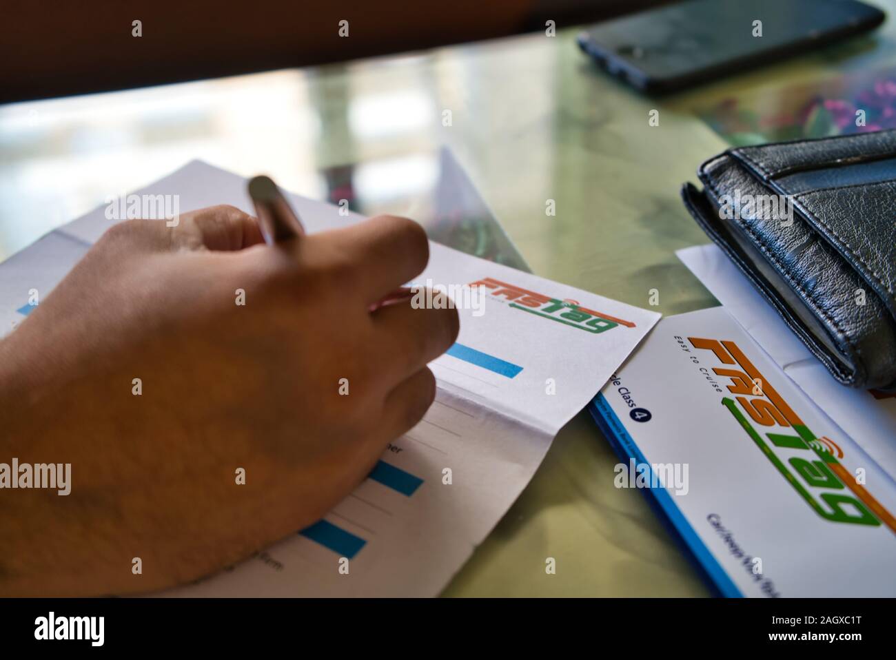 Fast Tag application form being filled with a fountain pen, along with ...