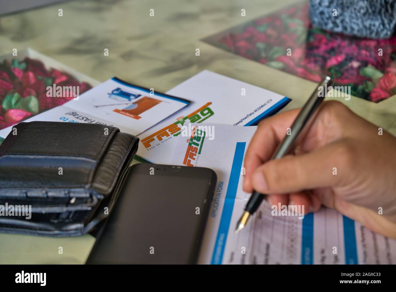 Fast Tag application form being filled with a fountain pen, along with ...