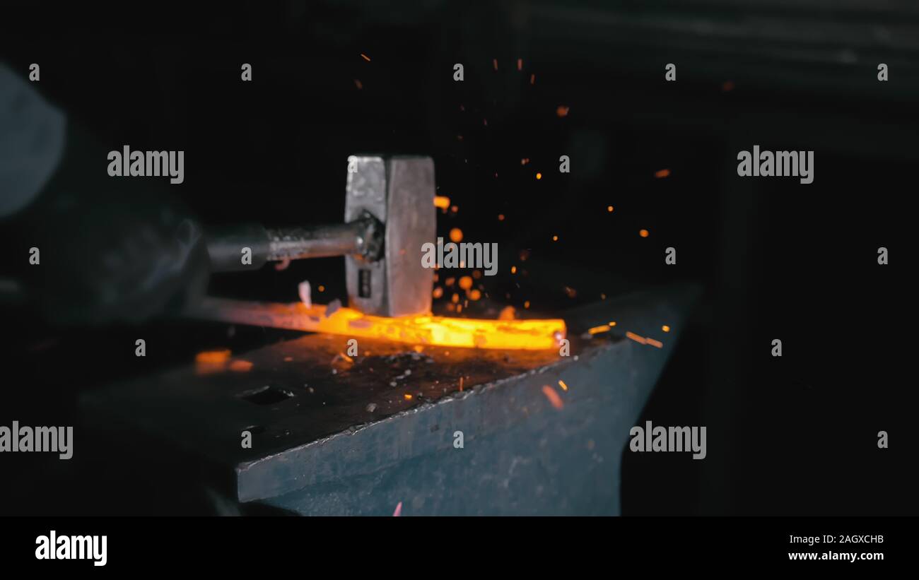 Forge workshop. Smithy manual production. Hands of smith with hammer ...