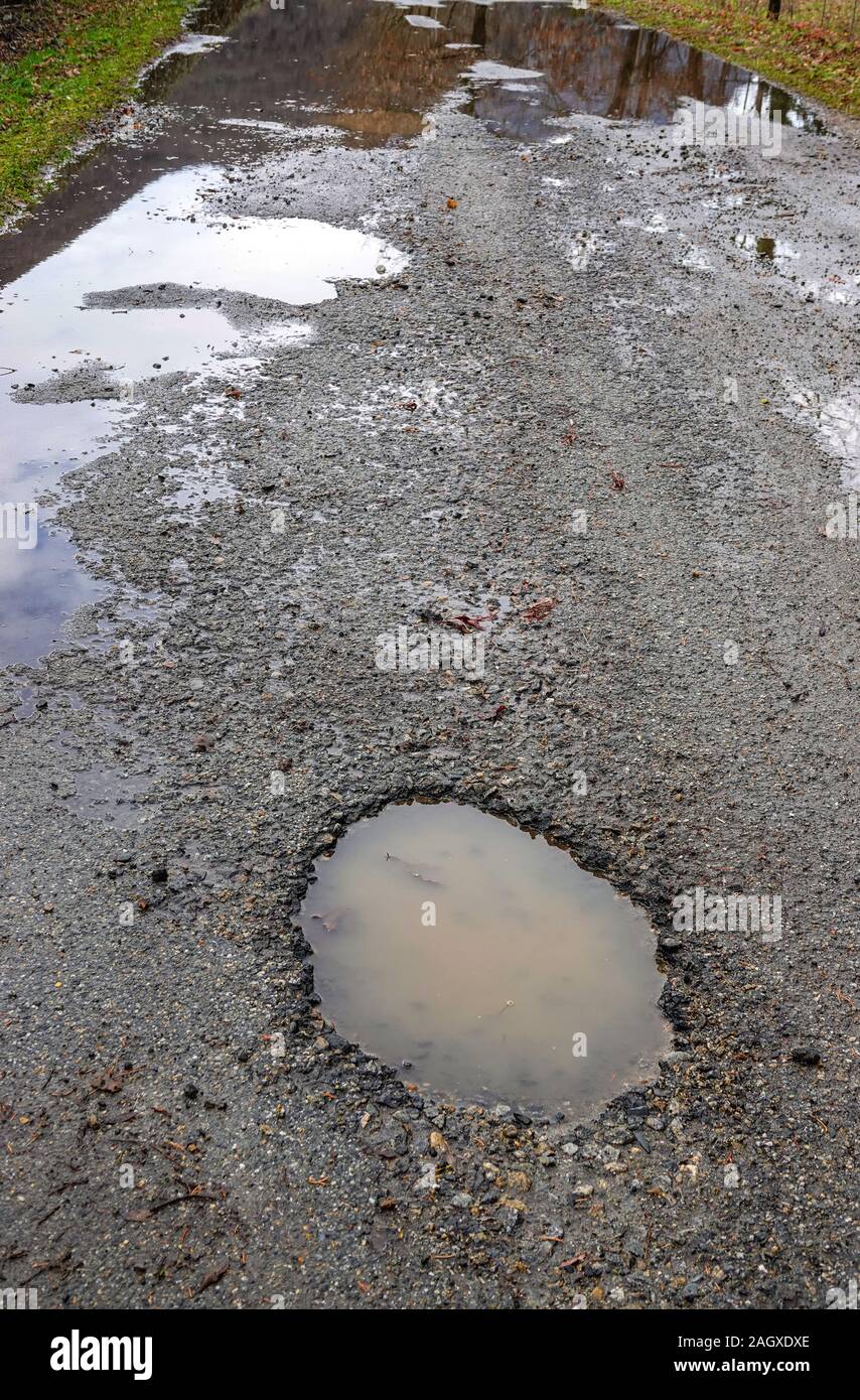 Large water-filed pothole in centre of minor country road, France Stock ...