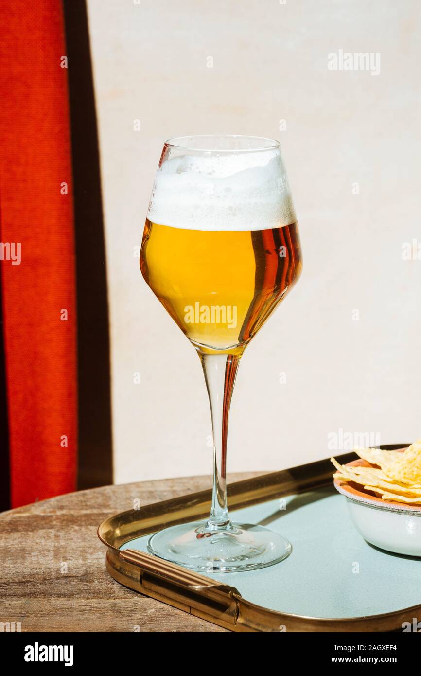 Beer in flute, pils or pilsner, with tortilla chips, light colorful ...