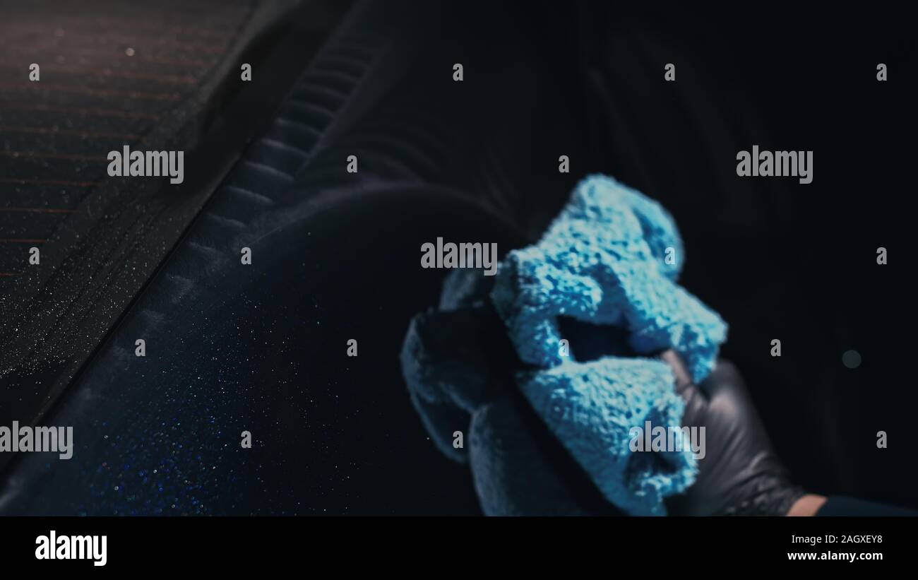 Using rag in palm of your hand, finish liquid car polish are removed ...