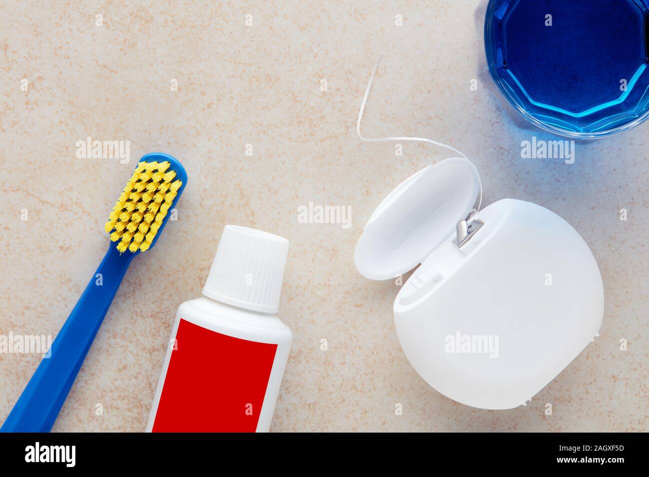 Toothbrush, toothpaste, dental floss and mouthwash on marble bathroom ...