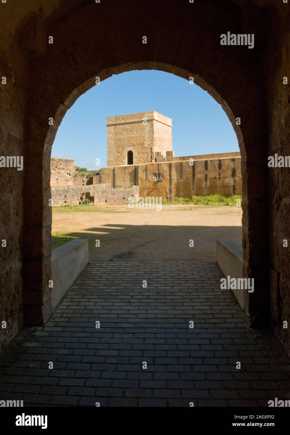 Archway into castle grounds and tower. Castillo de Alcalá de Guadaíra ...