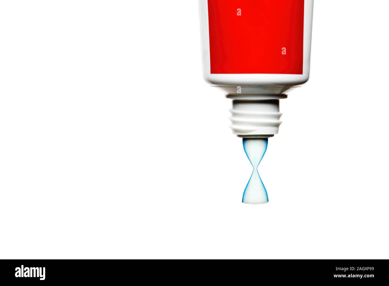 Toothpaste shaped as sand glass is squeezing from the toothpaste tube ...