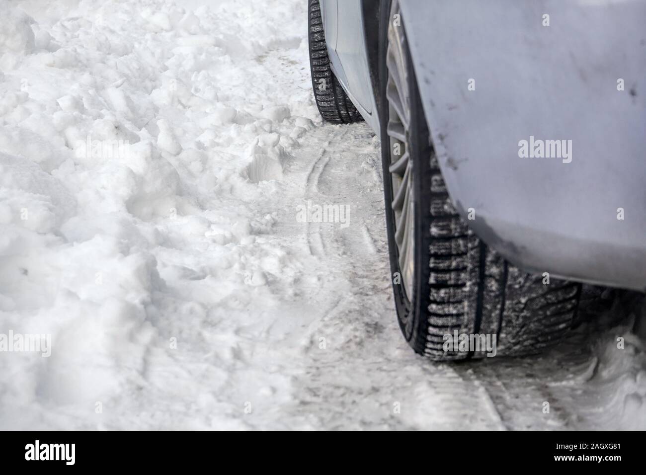 Detail of car tires on snow, tread print visible Stock Photo - Alamy
