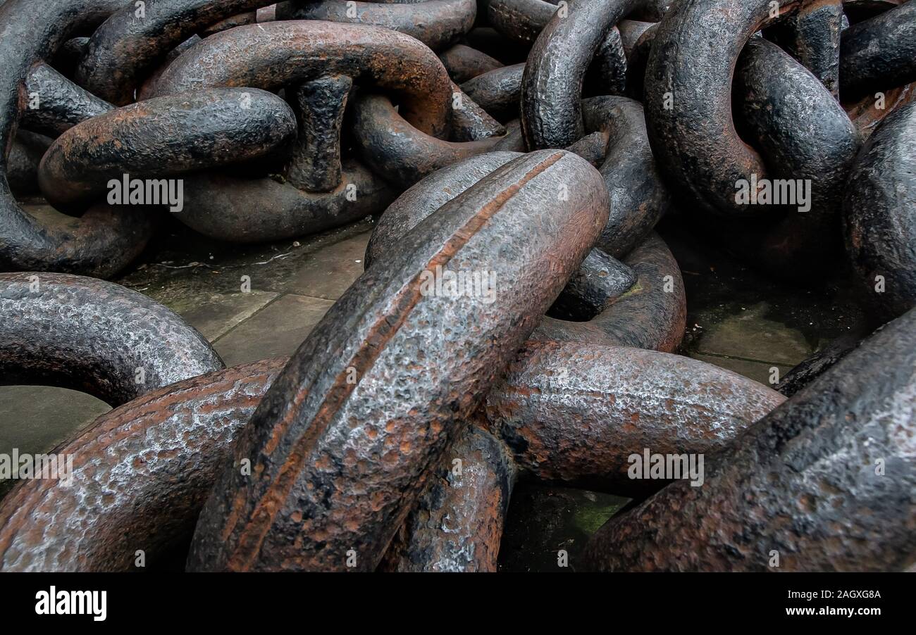 Large partially rusted eyes of huge ship chain Stock Photo - Alamy