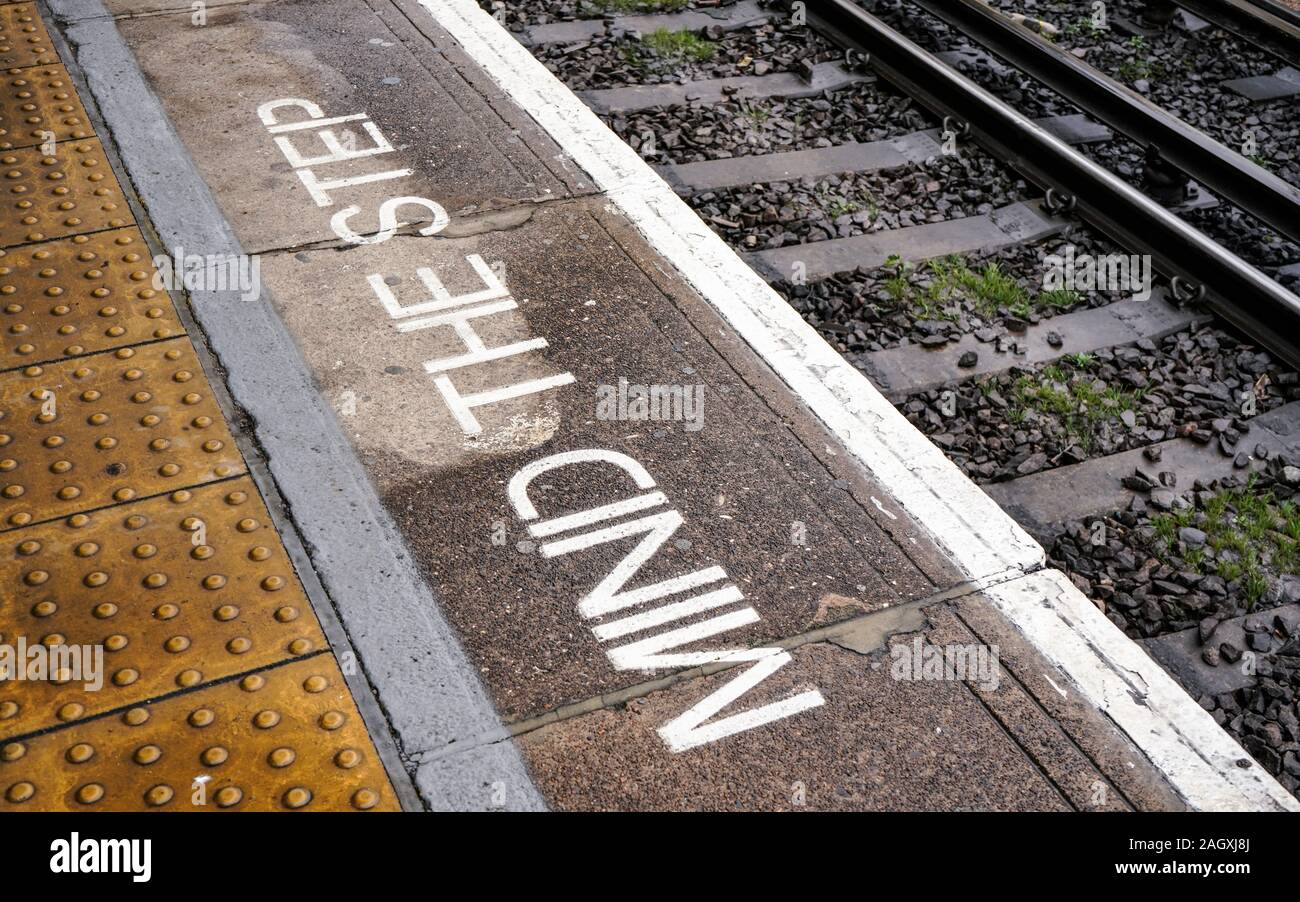 MIND THE STEP written on train platform near rails at London DLR ...