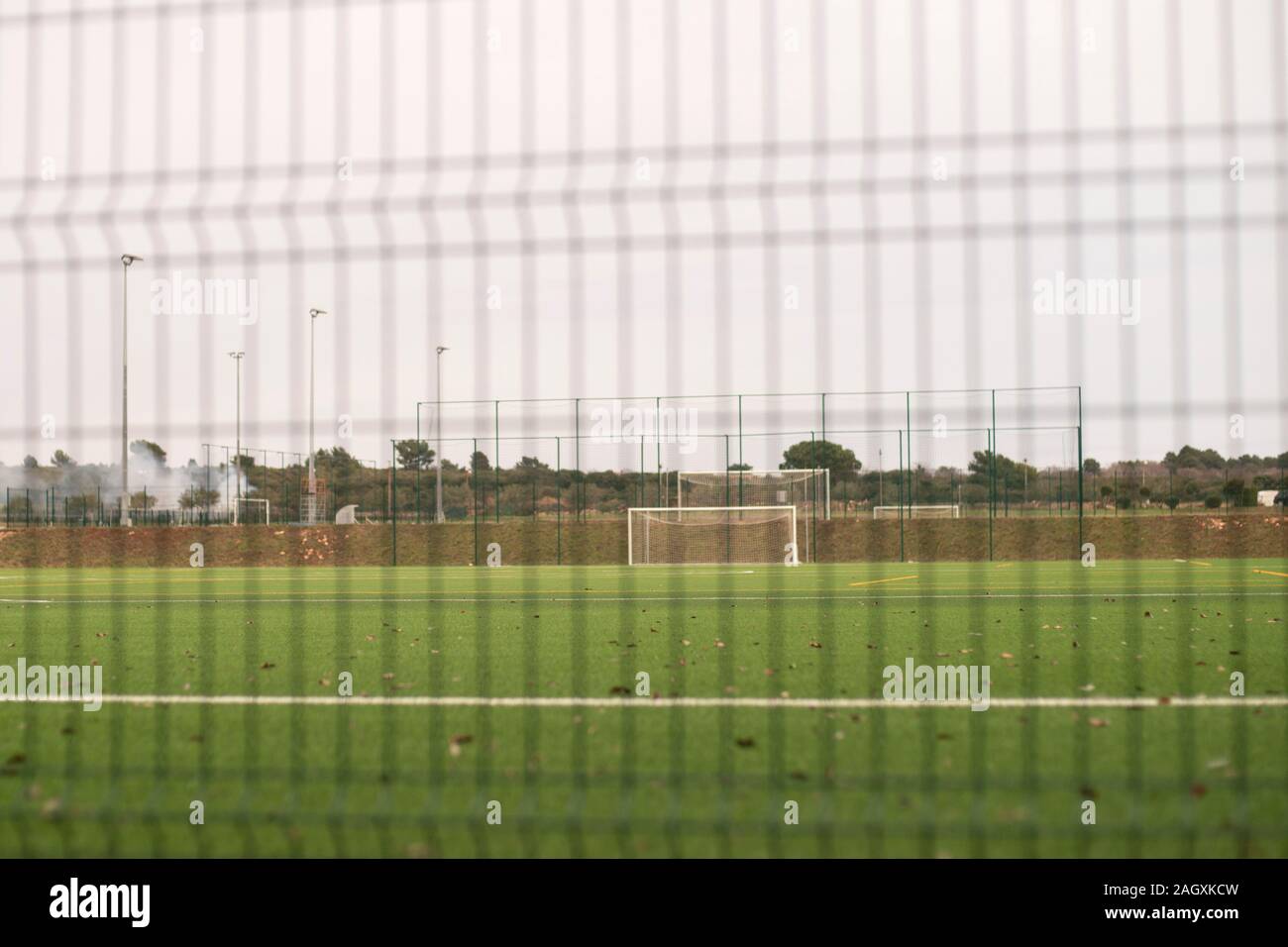 Football field through goal net Stock Photo - Alamy