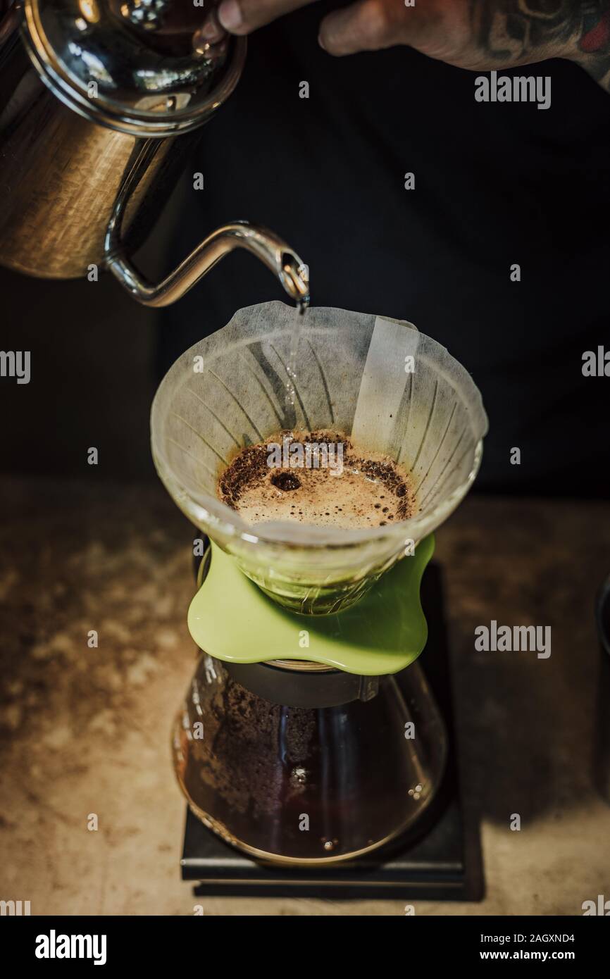 Hand drip coffee , Barista pouring water on coffee ground with filter ...