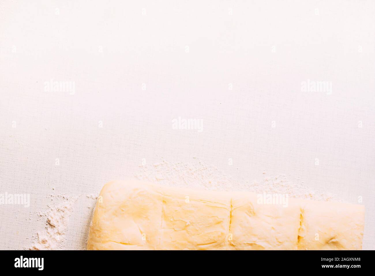 Puff pastry frozen sheet on the white background table in bakery with ...