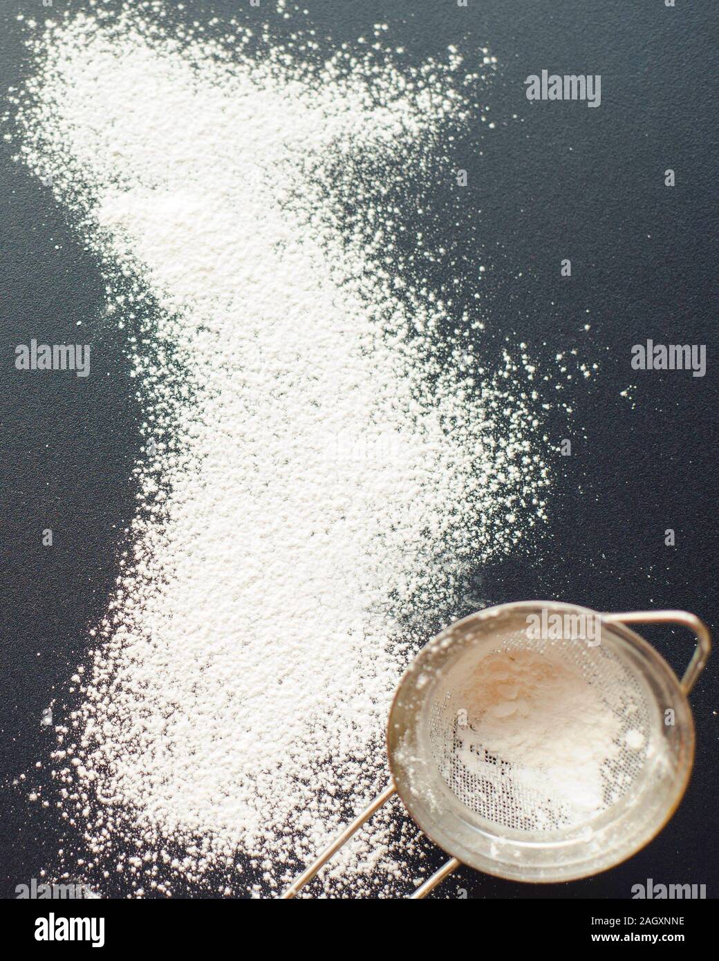 Powder scattered on a black table. The process of cooking deliciousness ...