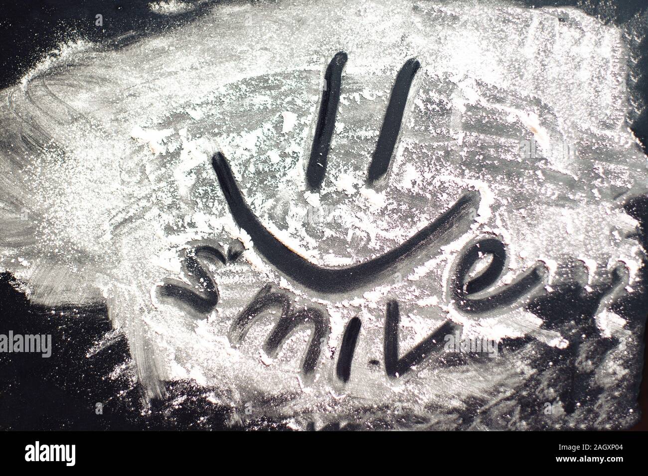 Word smile written and emoji on white flour. Inscription smile with ...