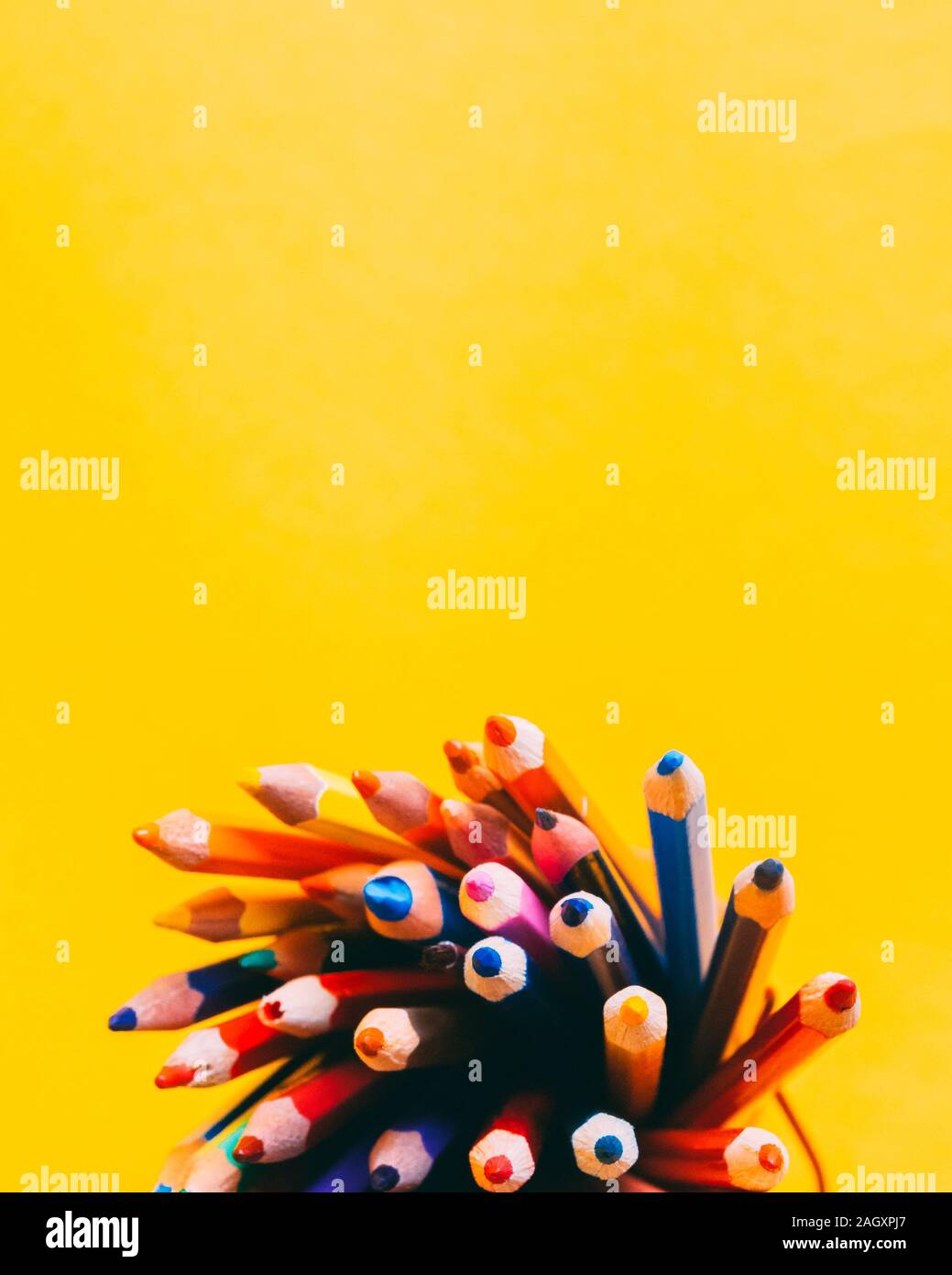 Colored pencils on the pastel yellow background. Flat lay. Crop for ...