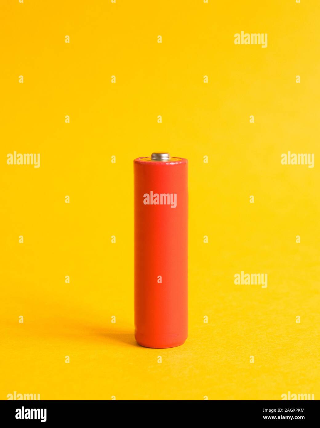 Single red battery on a yellow pastel background crop for instagram ...