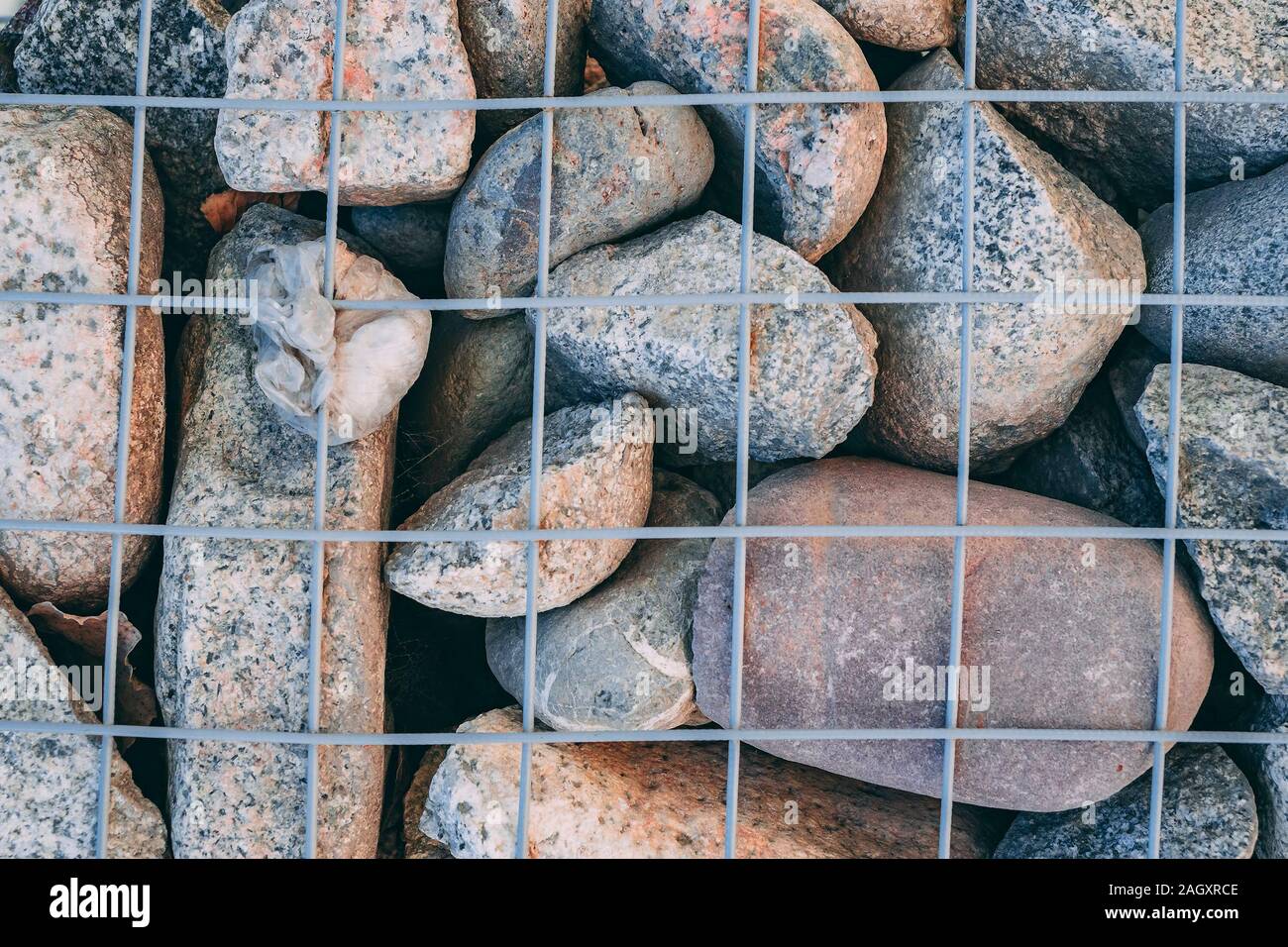 Stones behind bars. Rock texture. close up. flat lay Stock Photo - Alamy